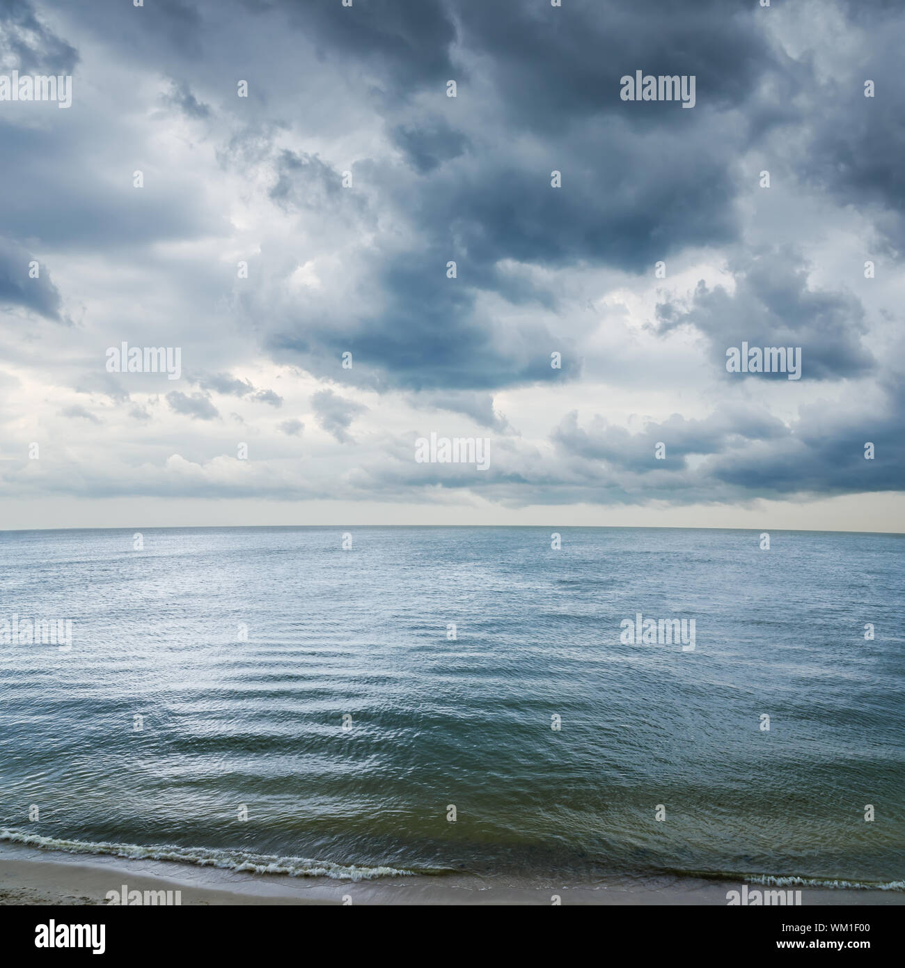 low dramatic clouds over dark water Stock Photo - Alamy