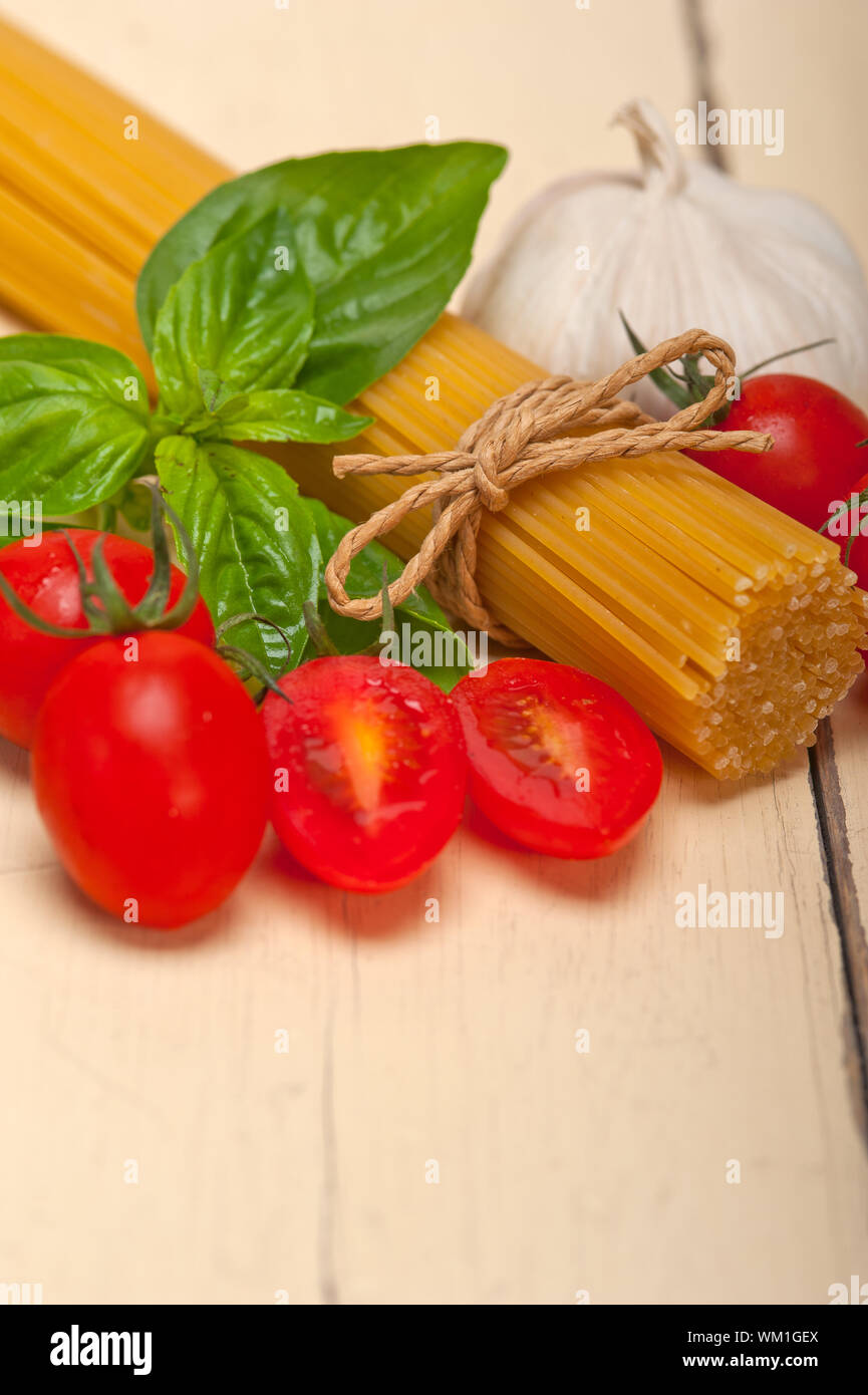 raw ingredients spaghetti pasta tomato and basil foundations of Italian ...