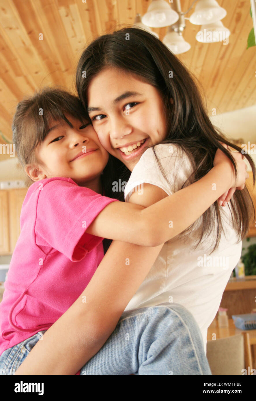 Two sisters hugging Stock Photo - Alamy