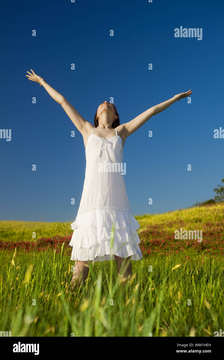Beautiful young woman relaxing on the field Stock Photo - Alamy