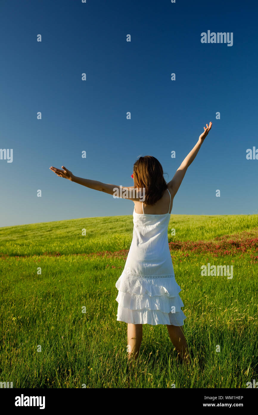 Beautiful young woman relaxing on the field Stock Photo - Alamy