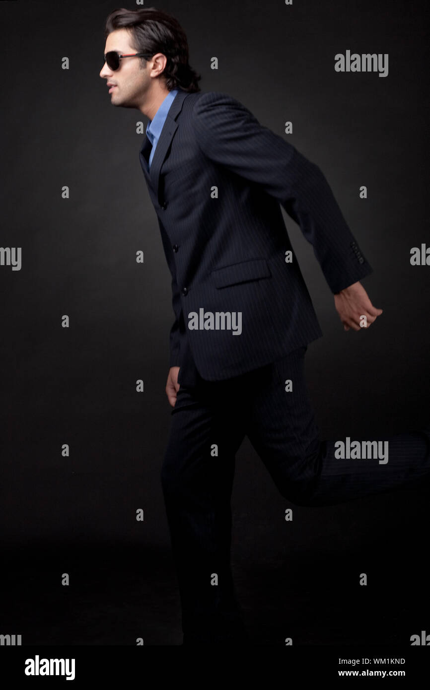 young business man side view in isolated black background Stock Photo ...