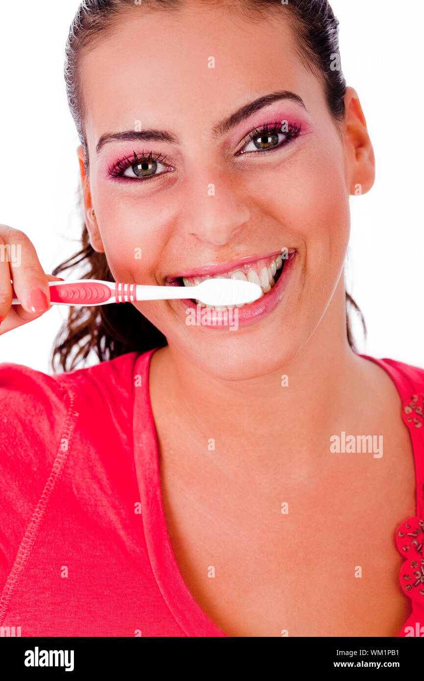 closeup of a cute girl brusing her teeth in isolated white backround ...