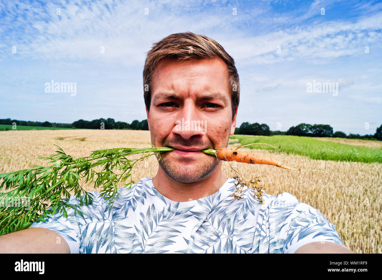 Man holding carrot mouth hi-res stock photography and images - Alamy