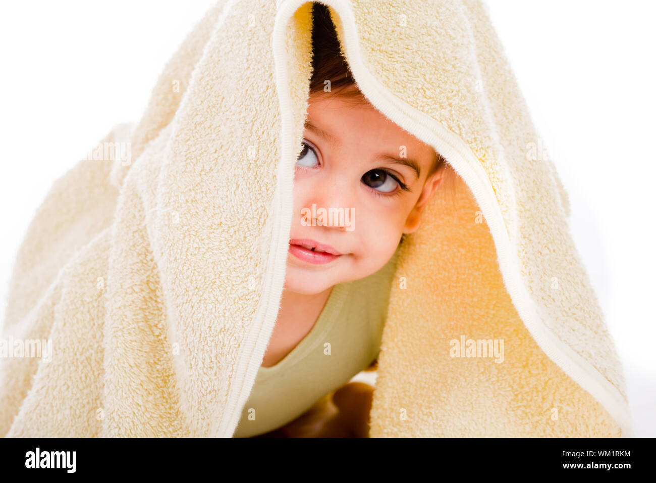 cute Baby looking out from under the blanket his isolated white ...