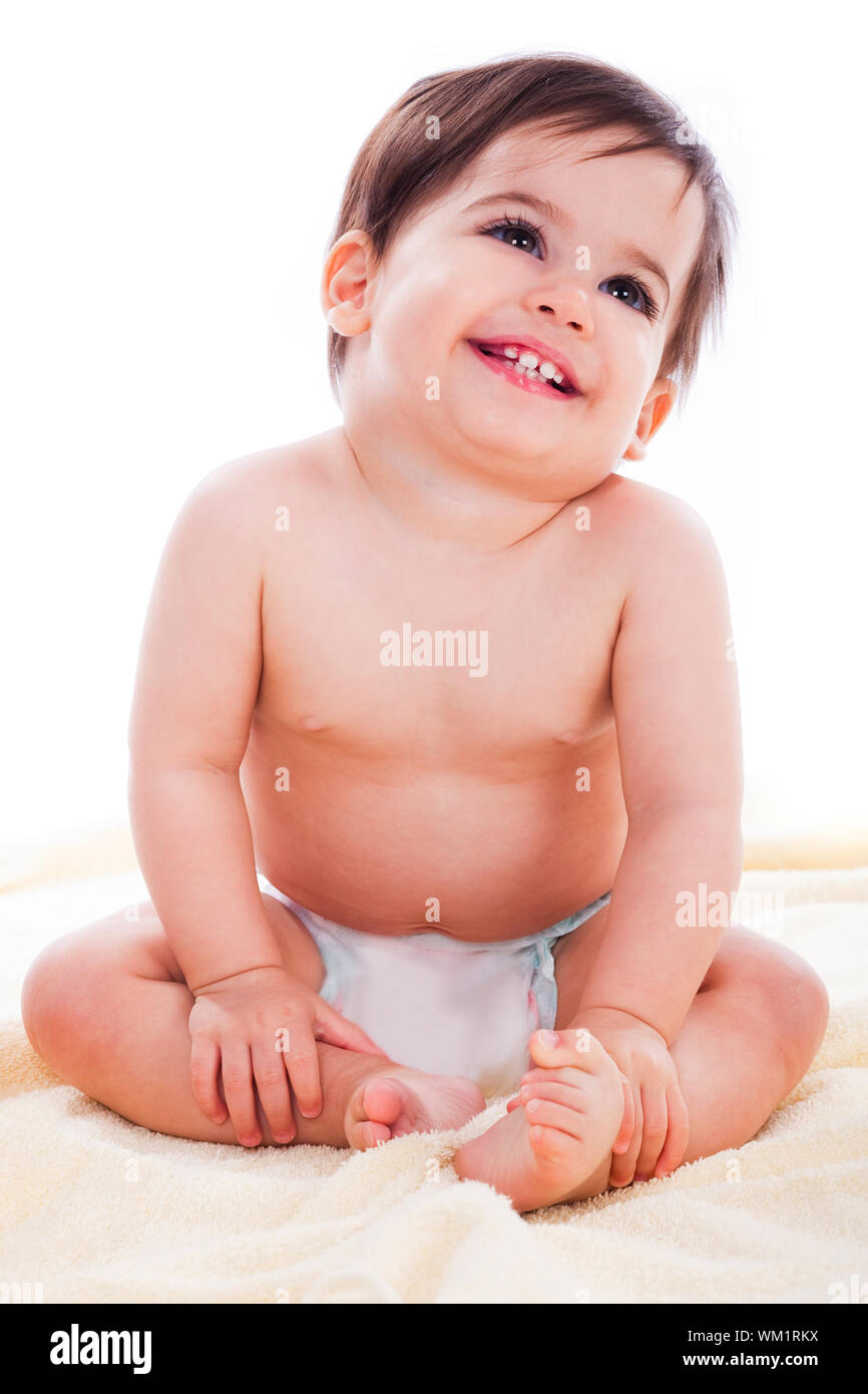 Baby sitting and smiling on white background Stock Photo - Alamy
