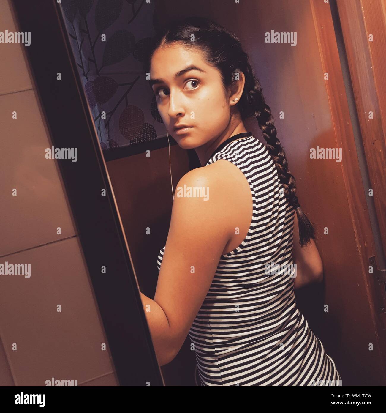 Woman looking over shoulder mirror hi-res stock photography and images ...