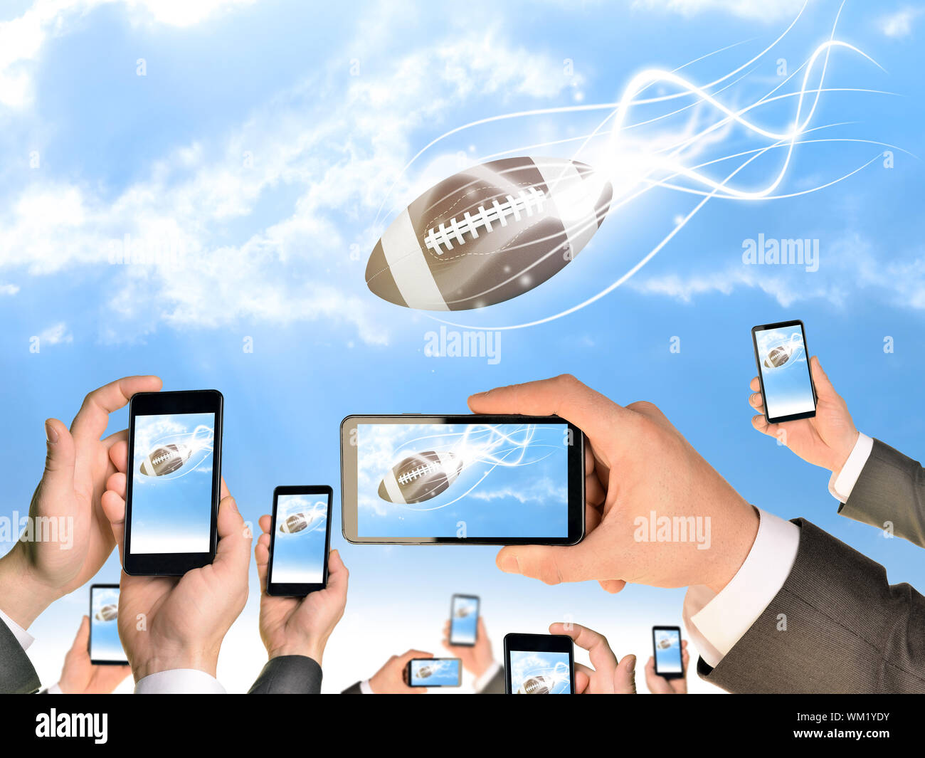 Hands holding smart phones and shoot video as falling American football ...