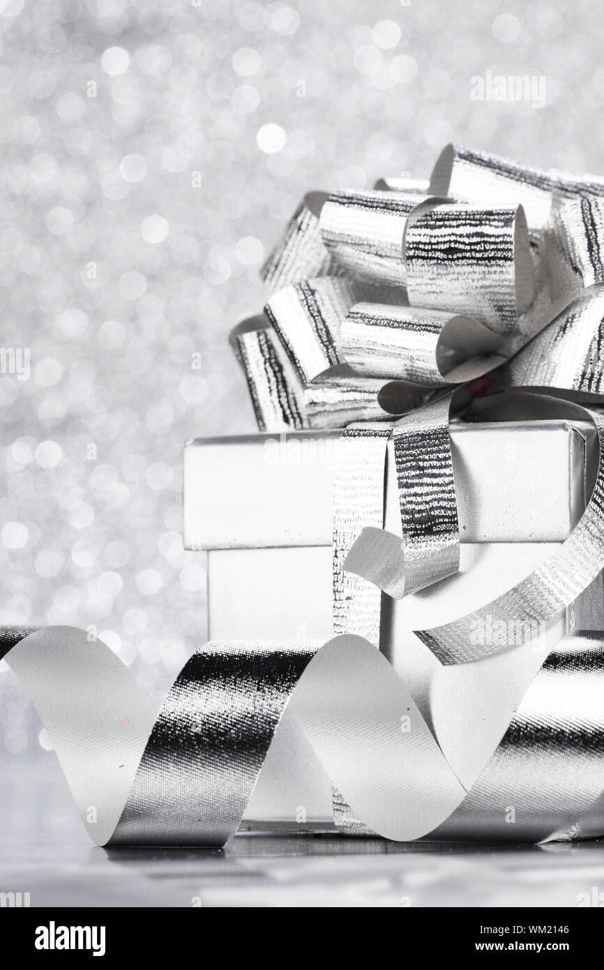 Decorative silver box with holiday gift on shiny glitter background ...