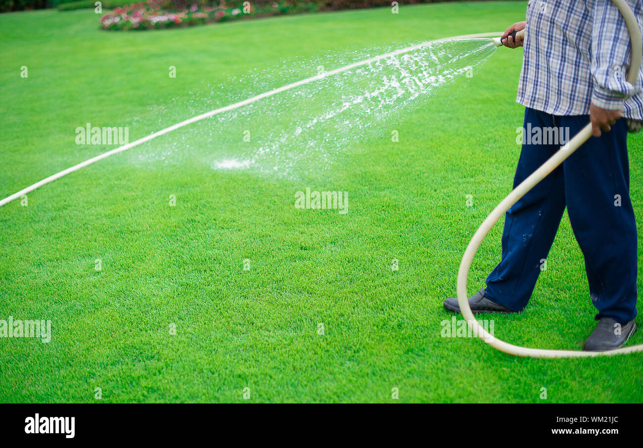 Man holding hose hi-res stock photography and images - Alamy