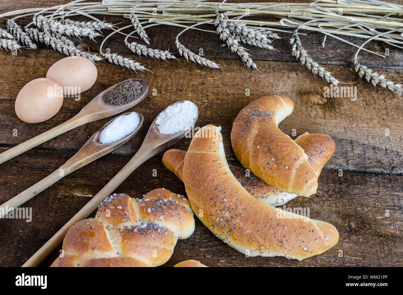 Roll, pastry from home bakery on wood table with wheat Stock Photo - Alamy