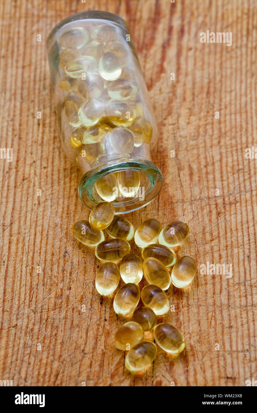 Cod liver oil pills in a small glass jar Stock Photo - Alamy