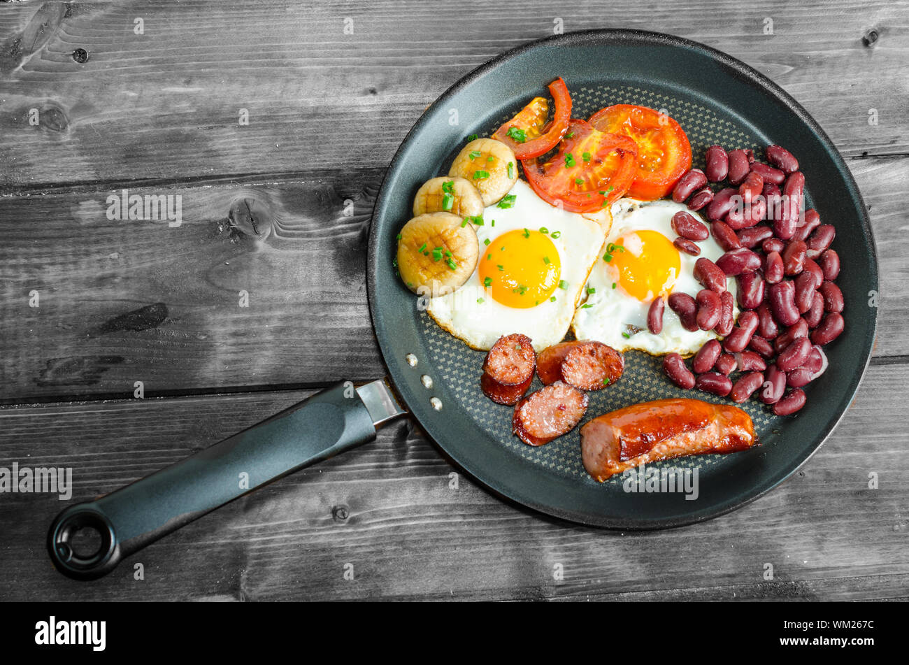 English breakfast on frying pan and wood table Stock Photo - Alamy