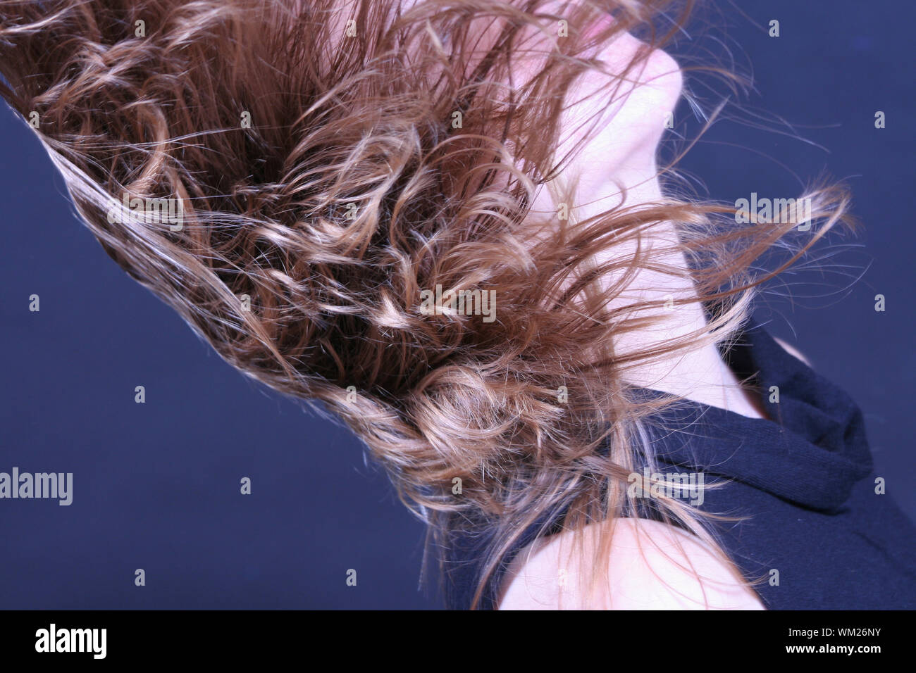 Yound woman tossing back hair, face covered Stock Photo - Alamy