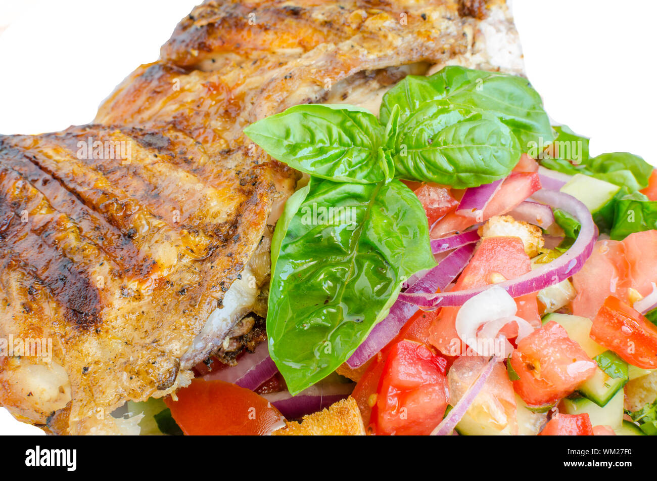 Chicken under a brick with panzanella salad. Pollo al mattone Stock ...