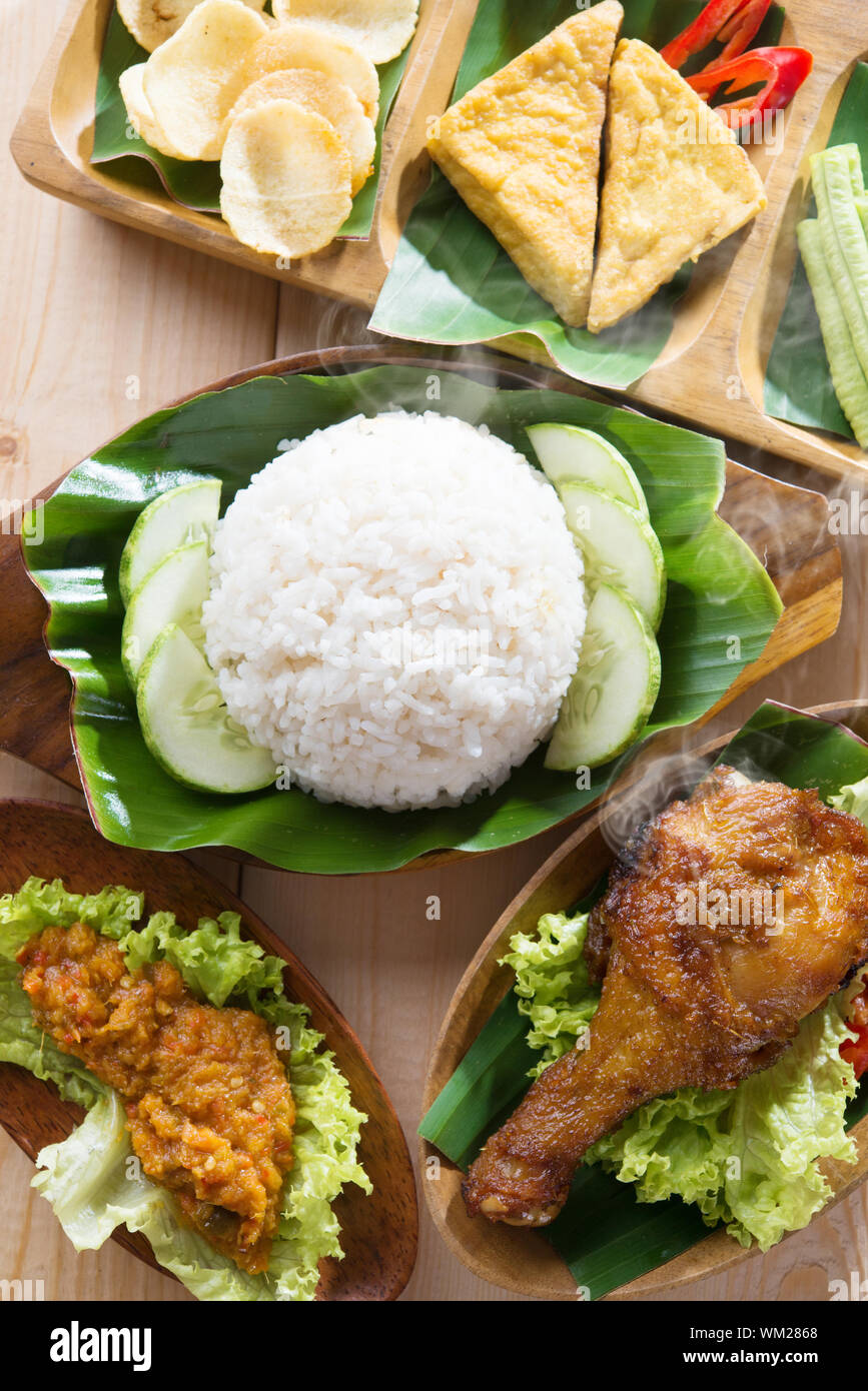 Famous traditional Indonesian food. Delicious nasi ayam penyet with ...