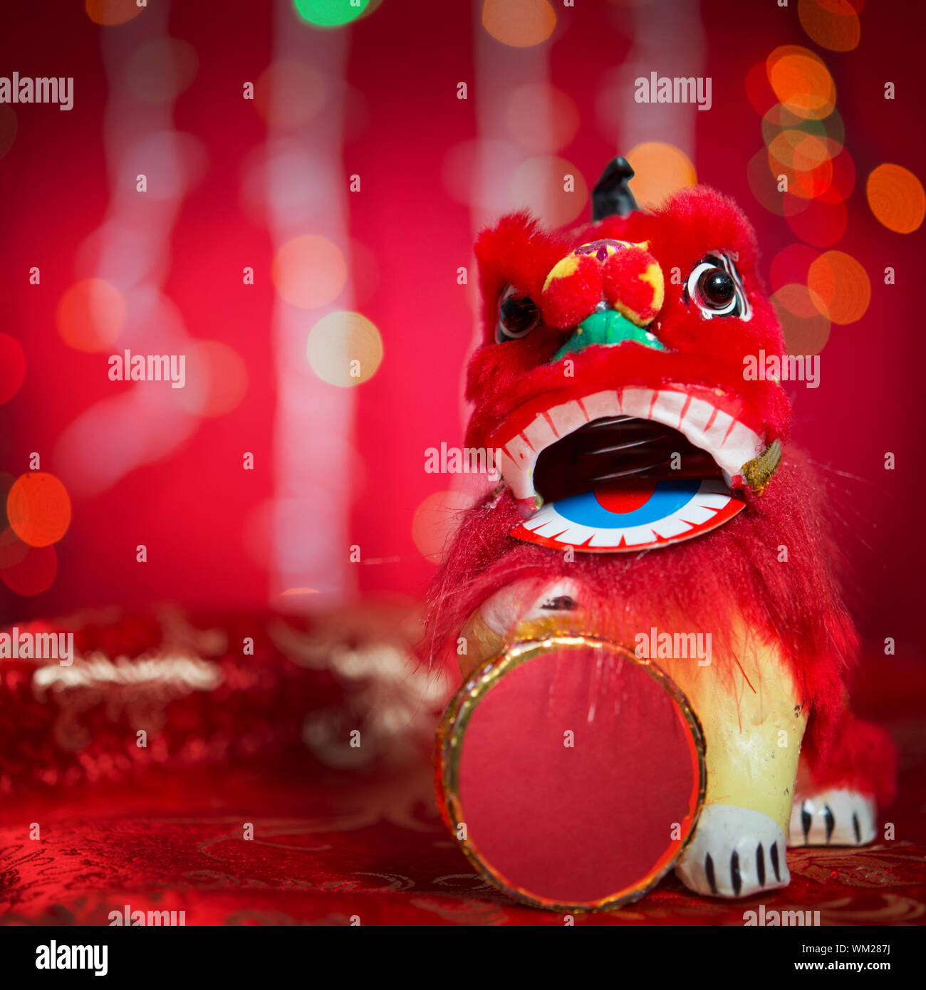 Chinese new year decorations, miniature dancing lion on red glitter ...