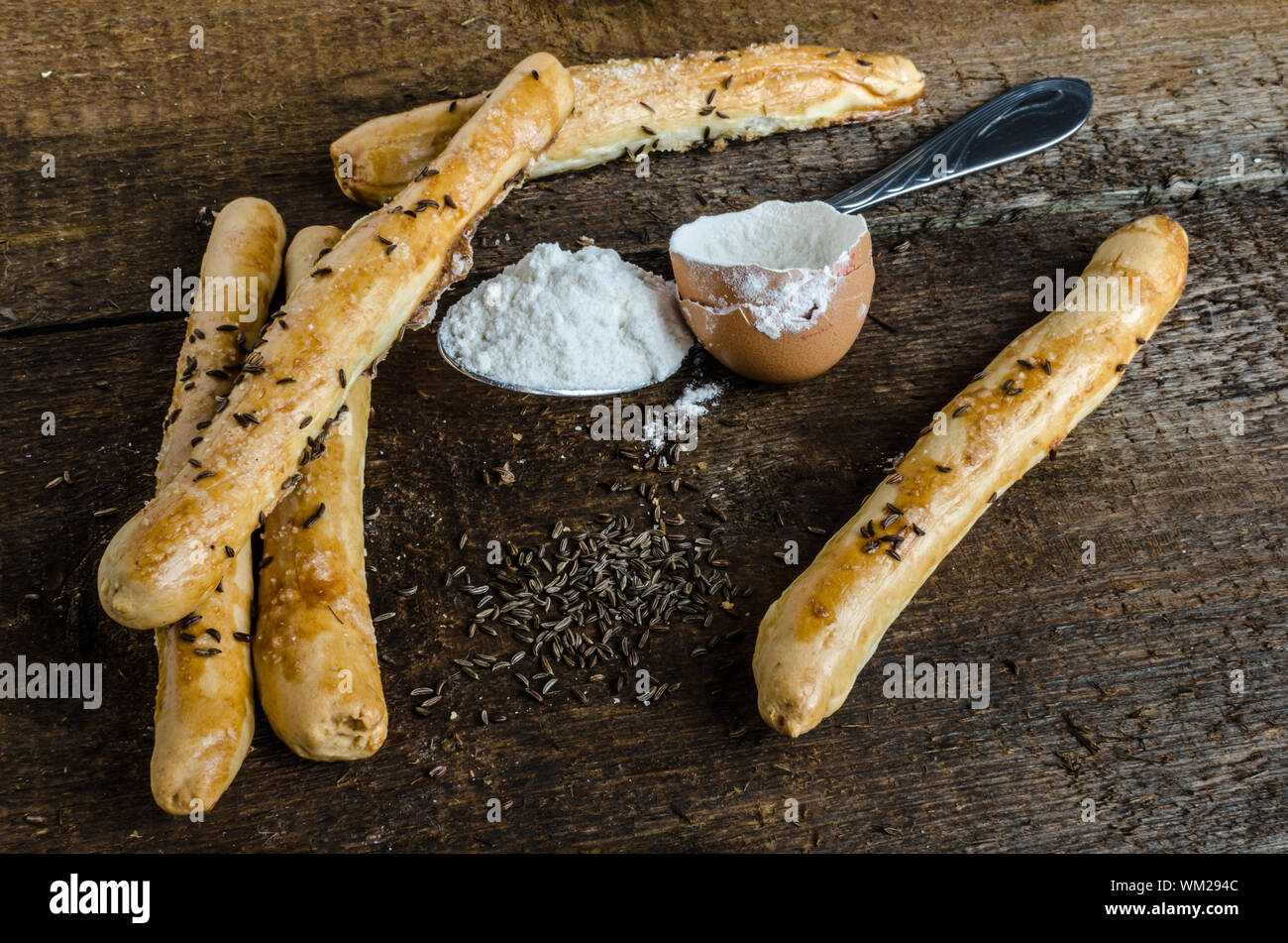 Homemade baked breadsticks on wood table with eggs Stock Photo - Alamy