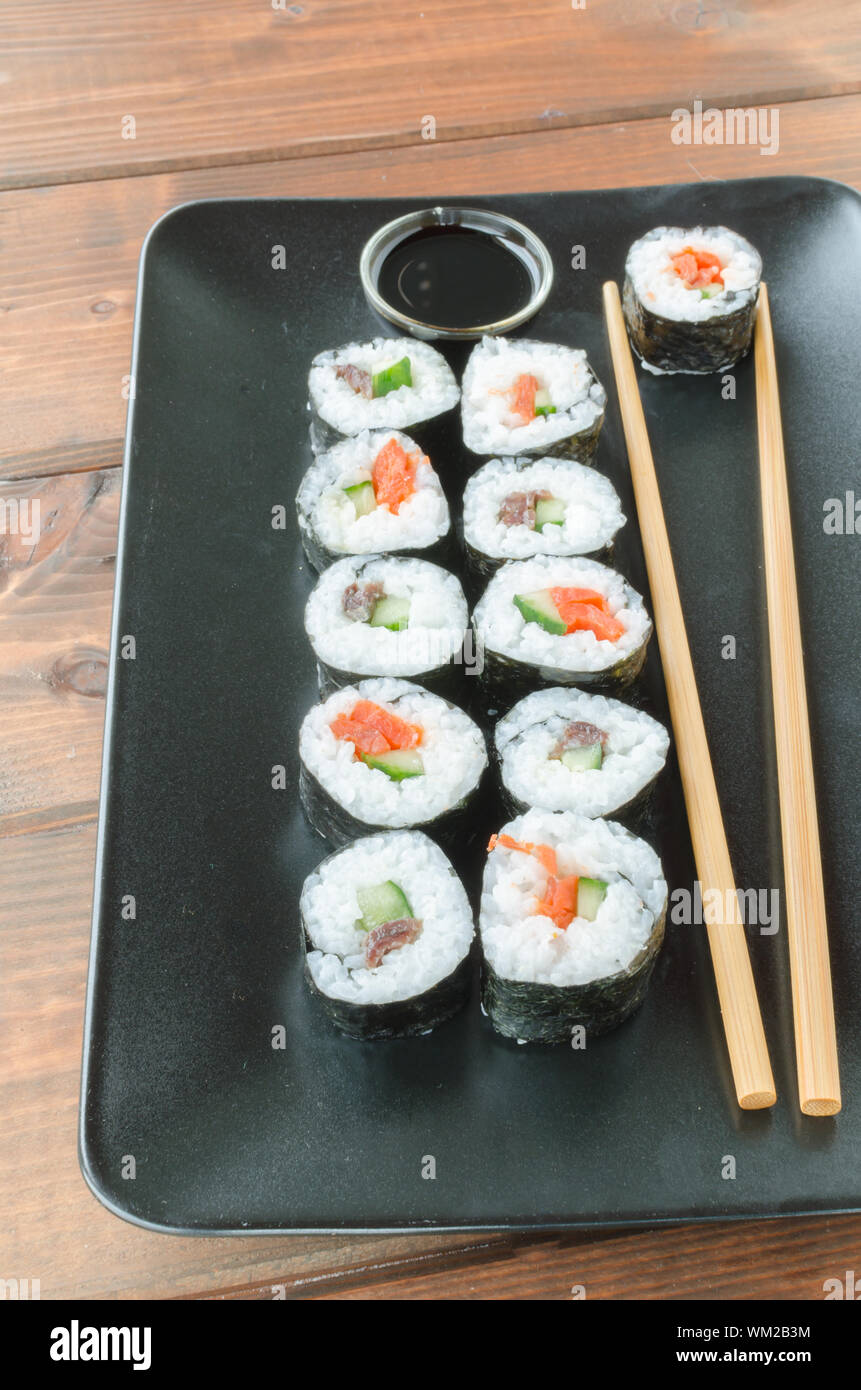 Maki-maki sushi with chopsticks, homemade on wood table Stock Photo - Alamy