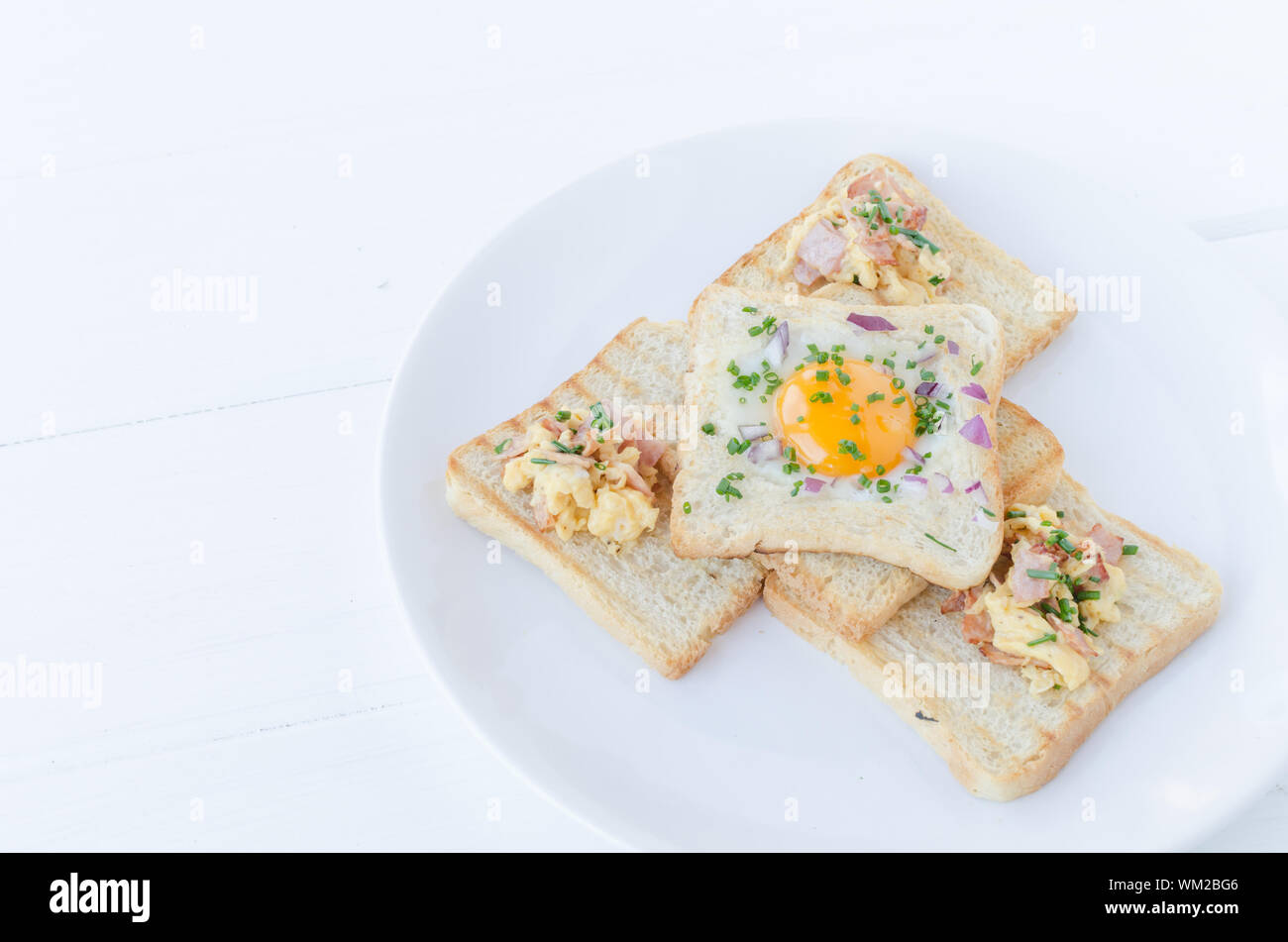 Fried egg inside toast with chive, ham and scrambled eggs Stock Photo ...