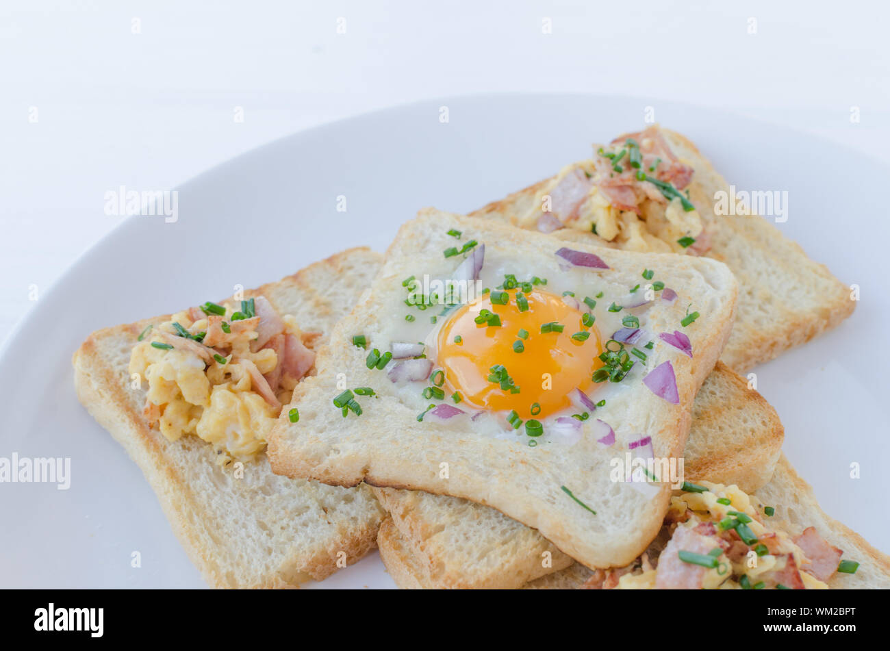 Fried egg inside toast with chive, ham and scrambled eggs Stock Photo ...