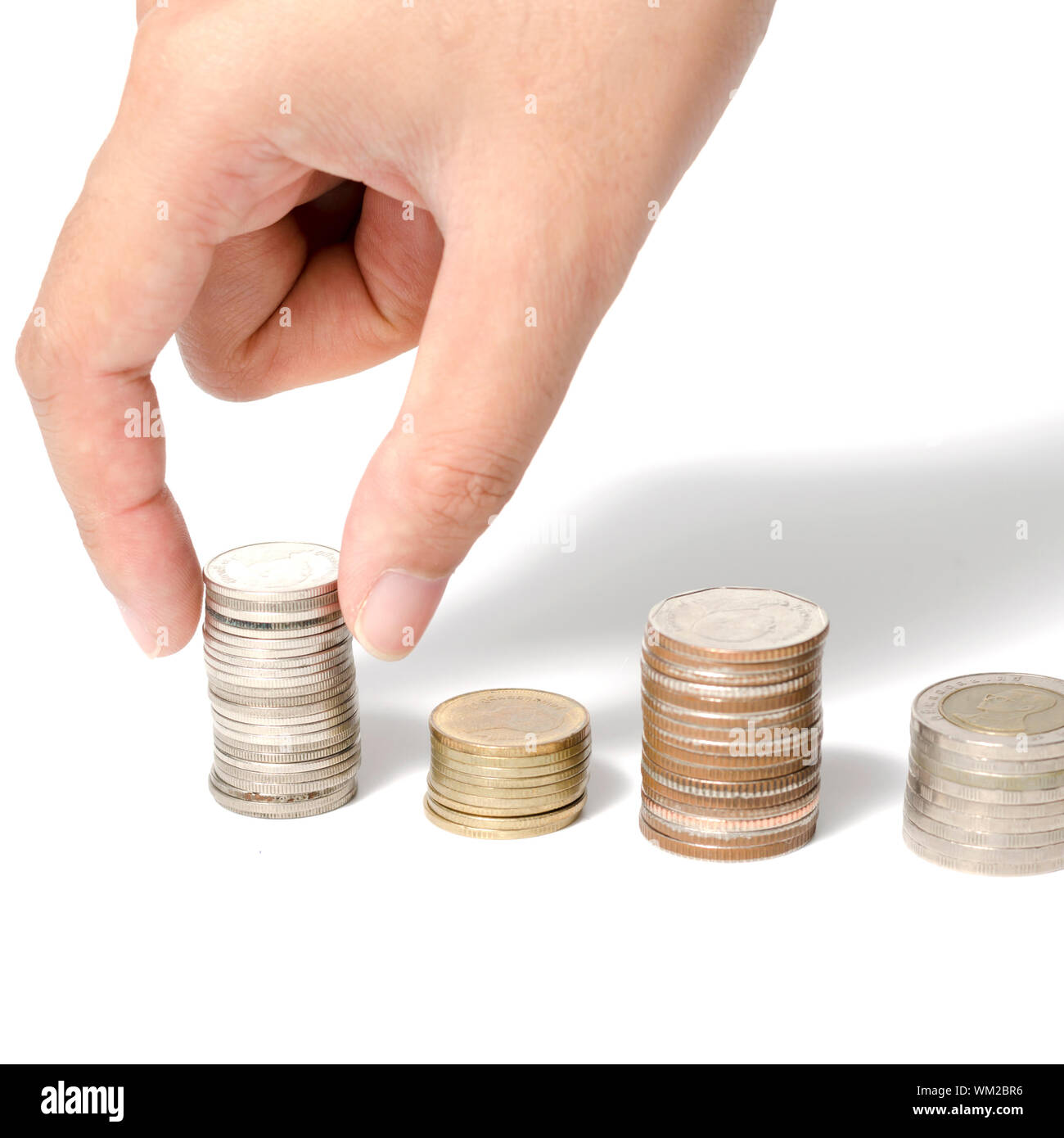 woman hand putting stack of coins on a white background Stock Photo - Alamy