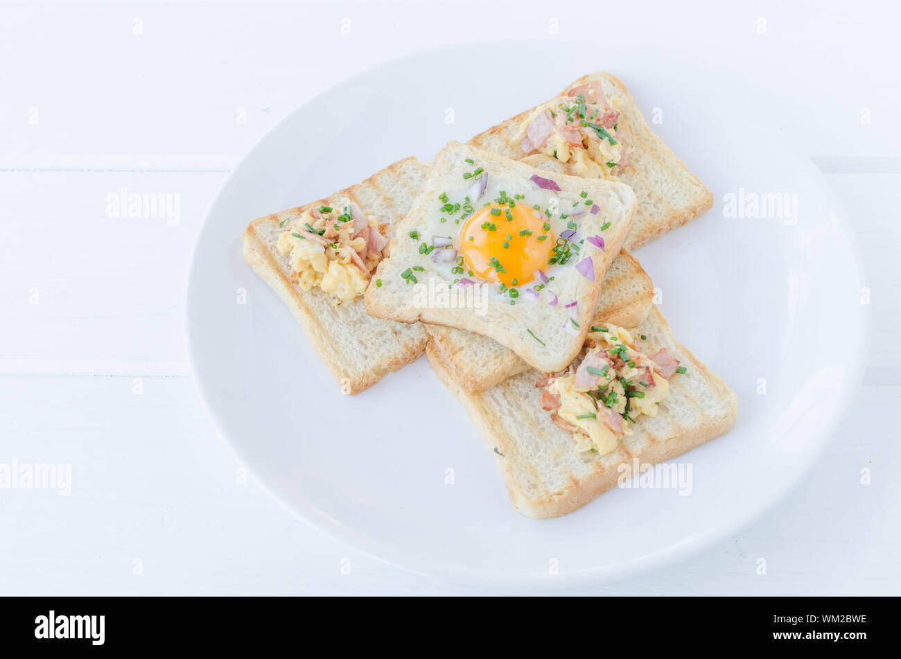 Fried egg inside toast with chive, ham and scrambled eggs Stock Photo ...