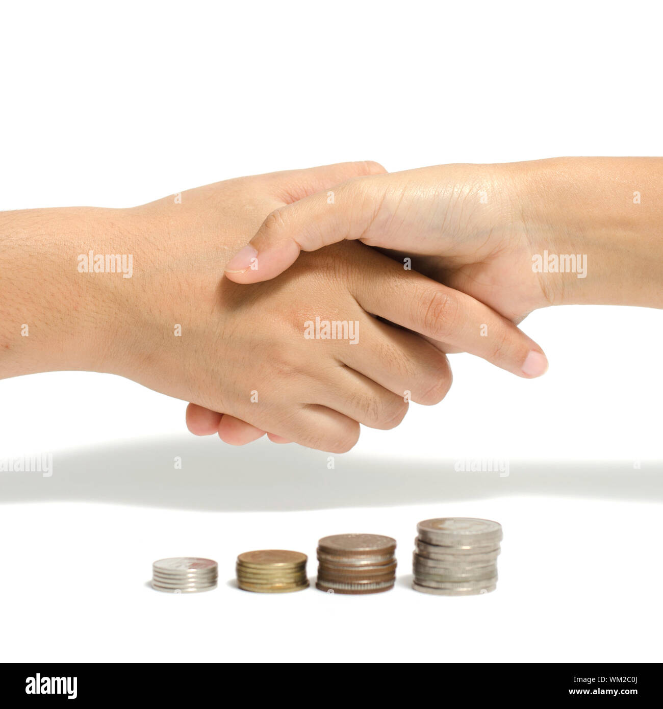 two people shake hand and coin business concept Stock Photo - Alamy