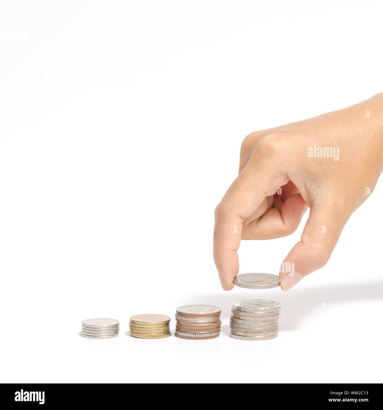 hand putting stack of coins Stock Photo - Alamy