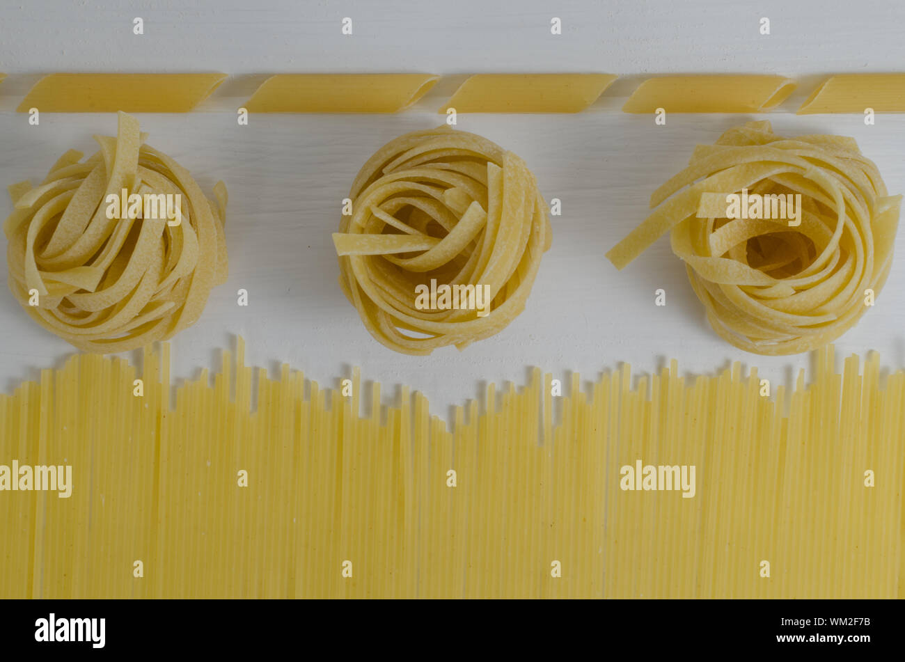 Simple picture variations of pasta, wood background Stock Photo - Alamy