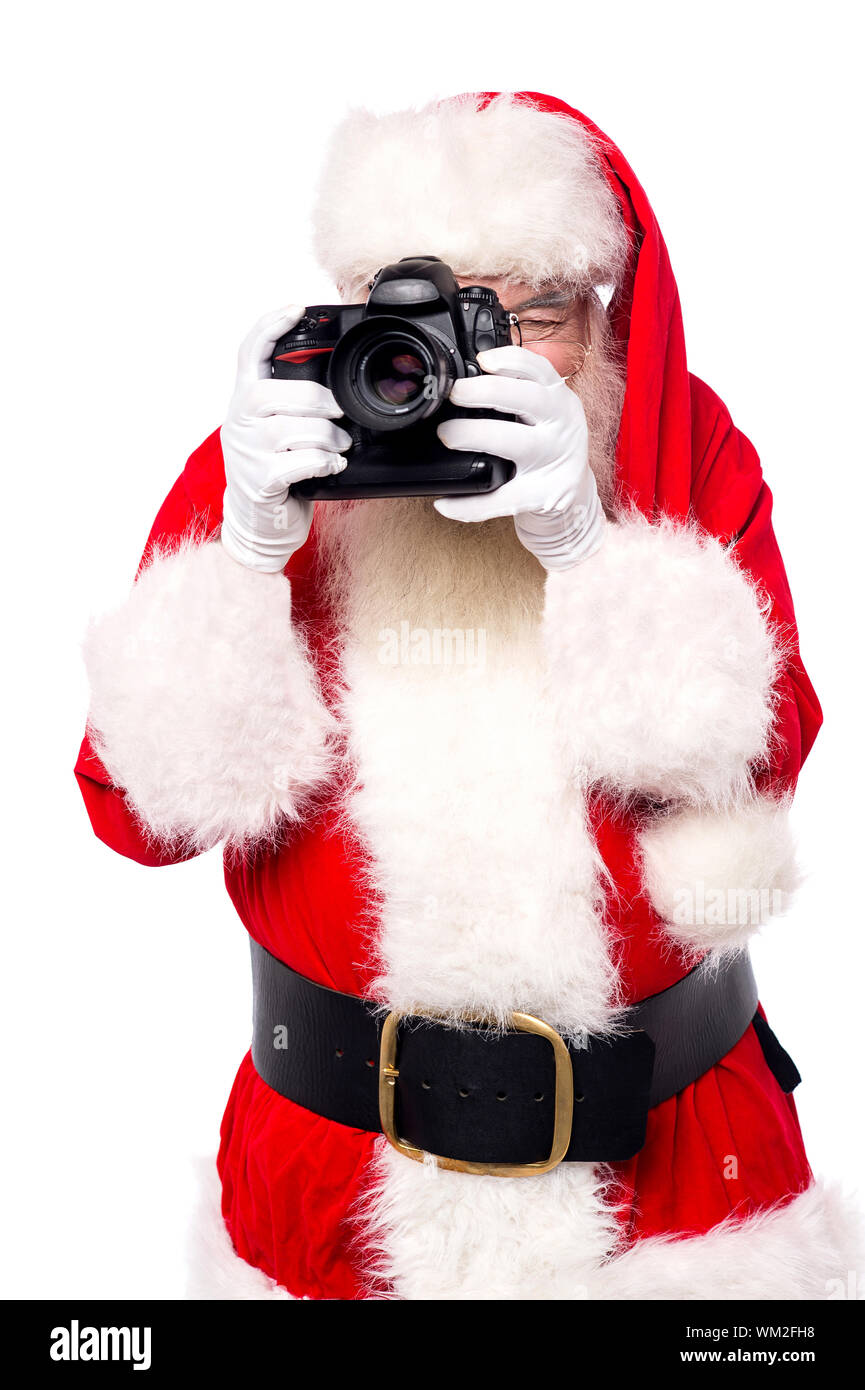 Santa claus taking photos with his new camera Stock Photo - Alamy