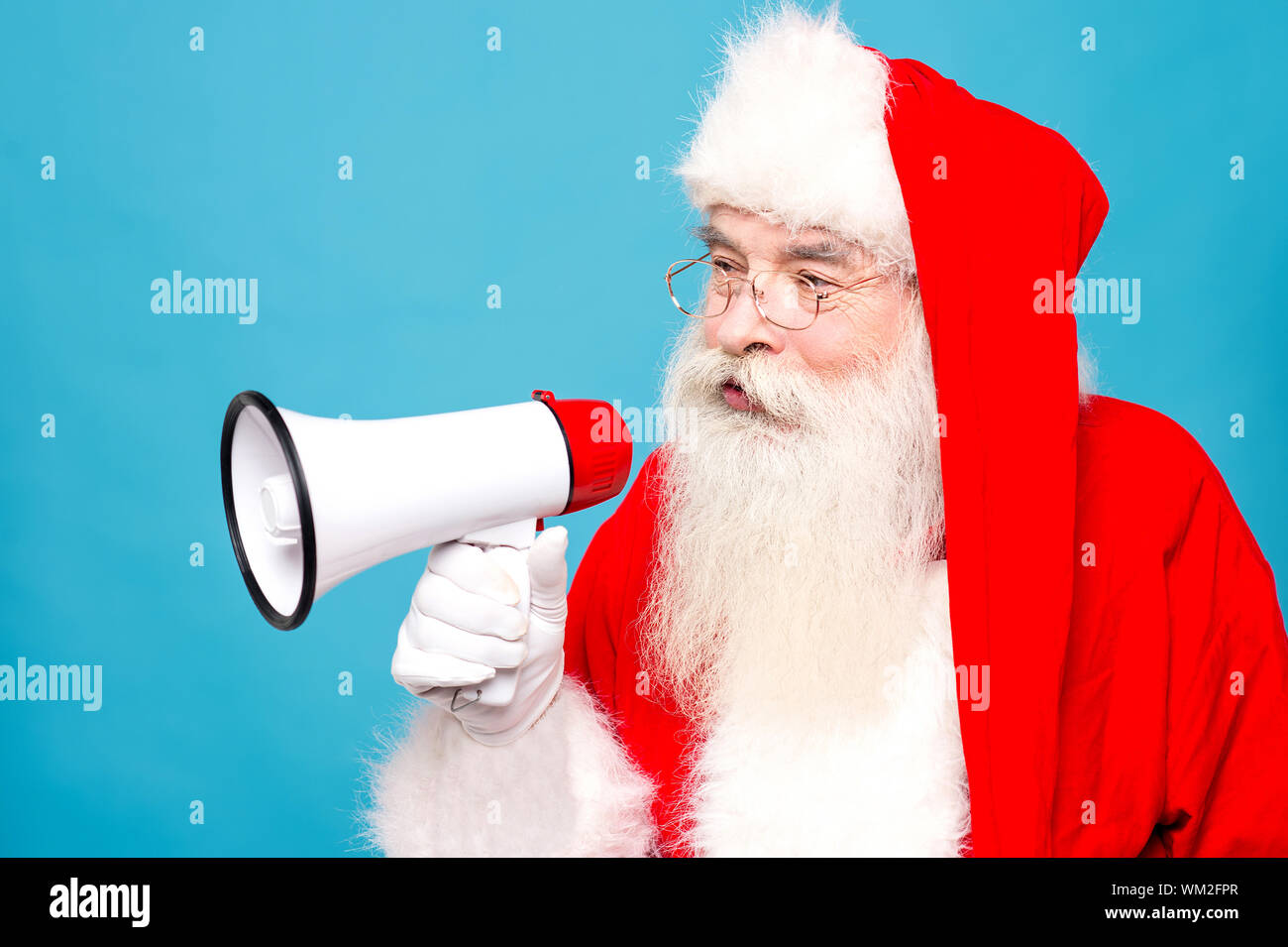 Santa claus making announcement in megaphone Stock Photo - Alamy