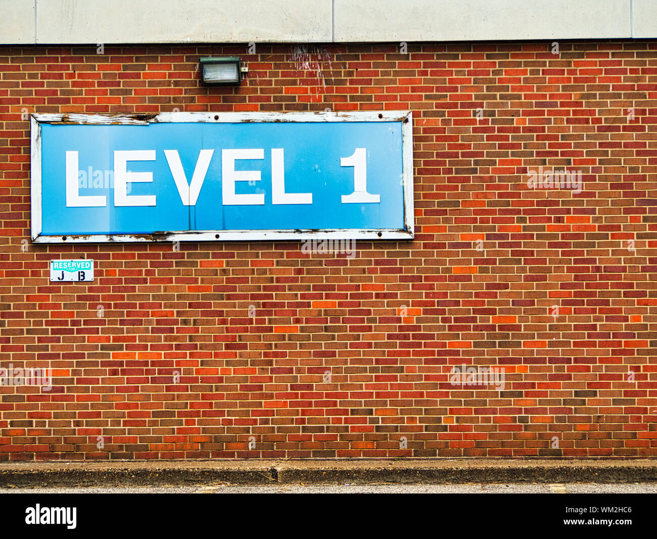 Brick wall with green level 1 sign Stock Photo - Alamy