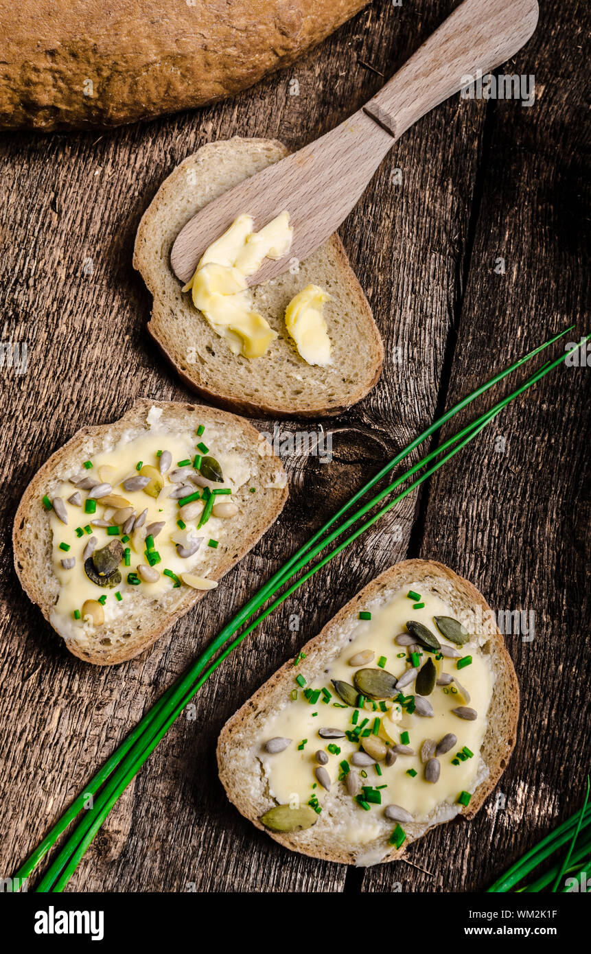 Homemade bread buttered with healthy seeds and herbs - chive Stock ...