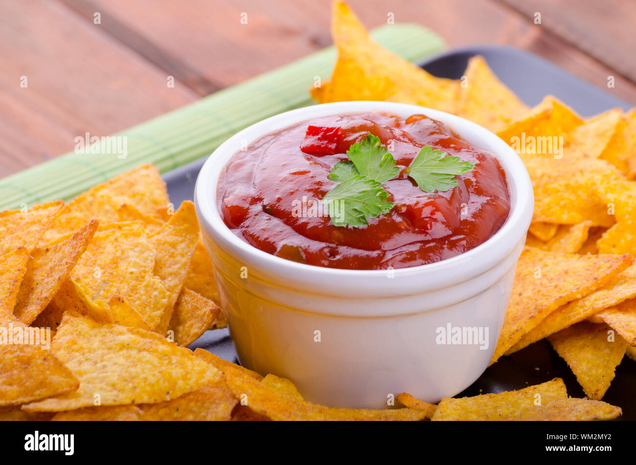 Tortilla chips with spicy tomato salsa with jalapeno Stock Photo - Alamy