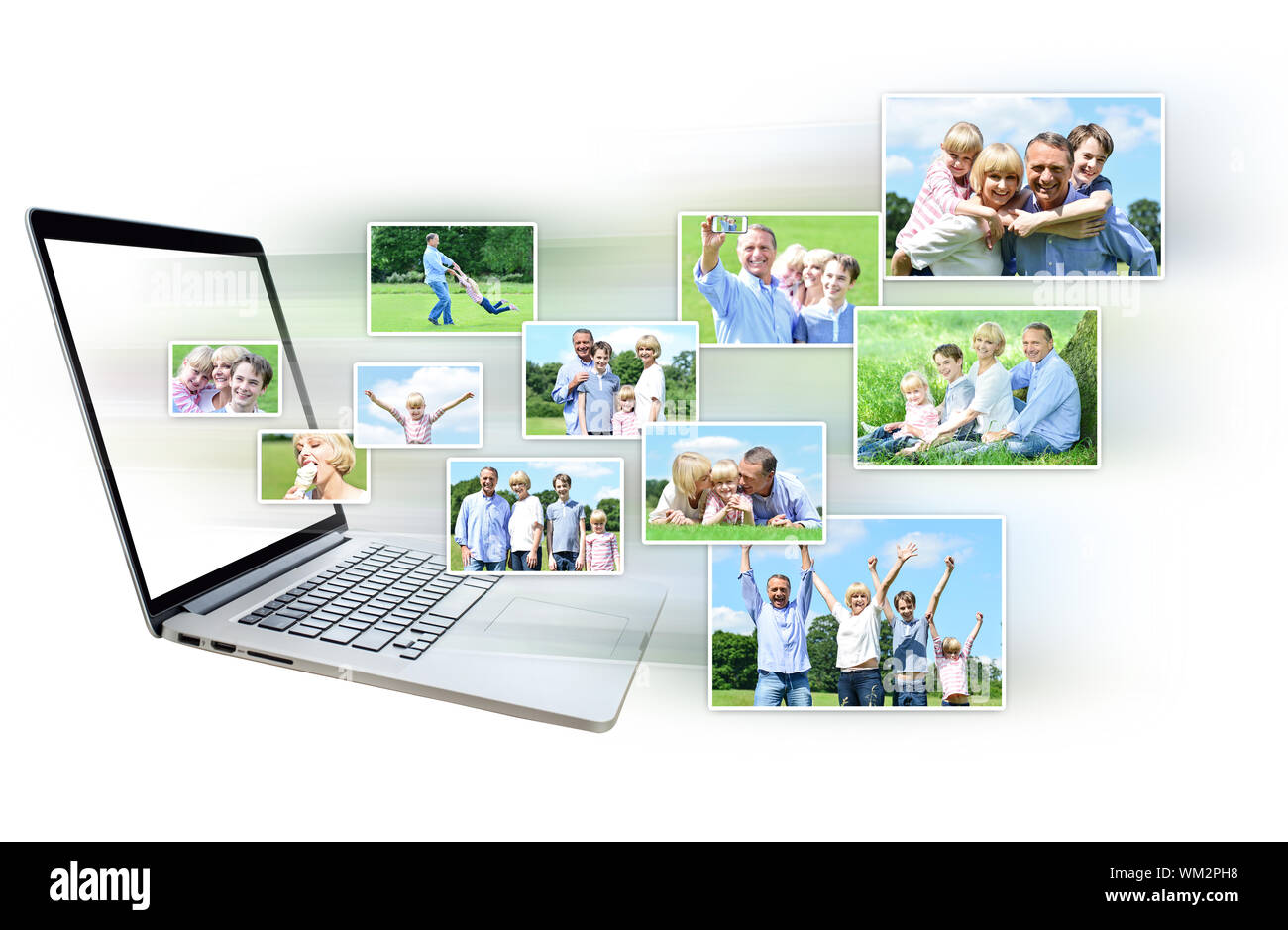 Pictures flying out of the laptop screen Stock Photo - Alamy