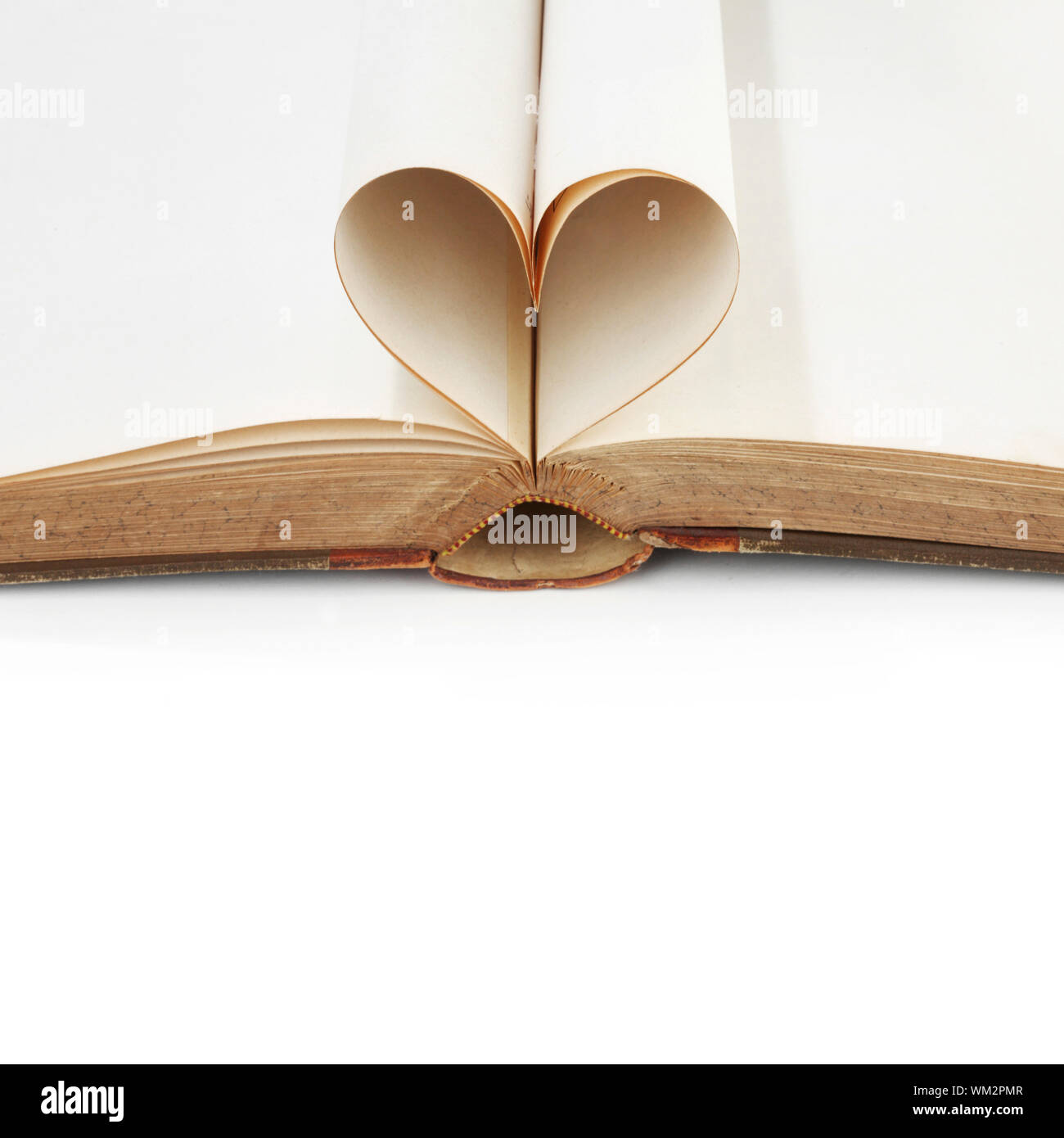Heart shaped book pages on white background Stock Photo - Alamy