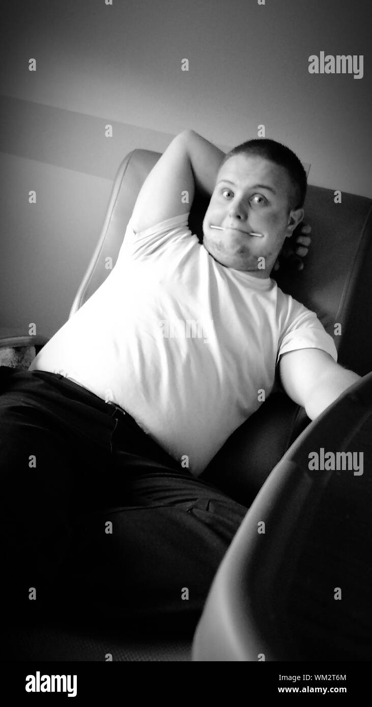 Portrait man lying on chair hi-res stock photography and images - Alamy