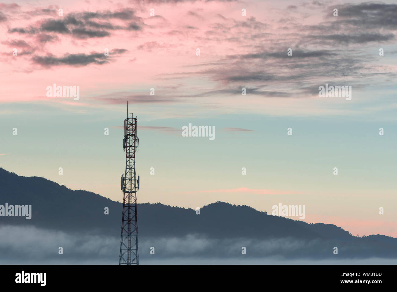 Telecommunication tower and sunset sky background Stock Photo - Alamy