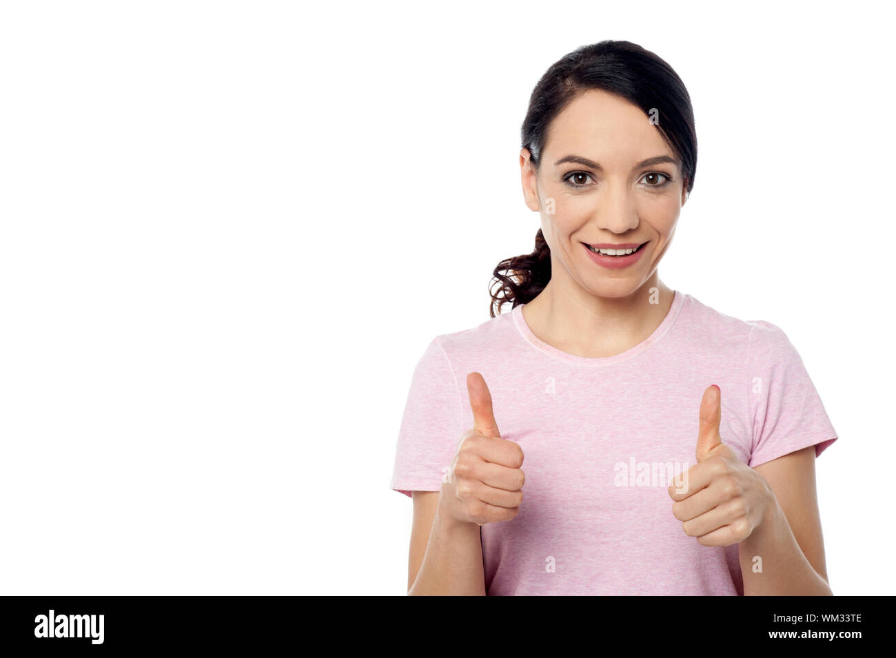 Young woman showing thumb up by two hands Stock Photo - Alamy