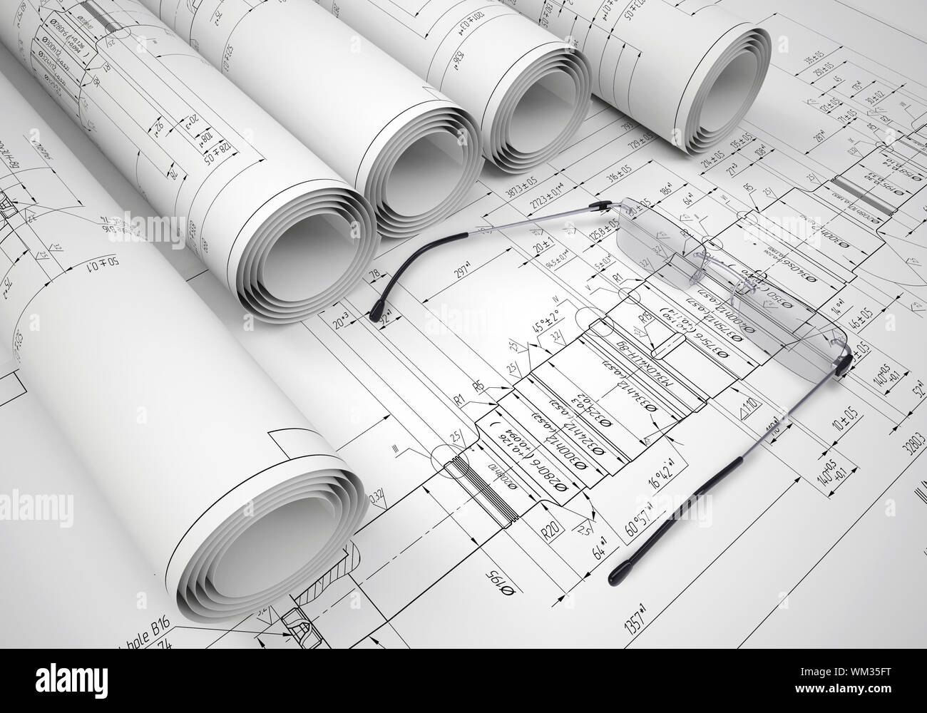 Scrolls of engineering drawings and glasses on drawing. Industrial ...