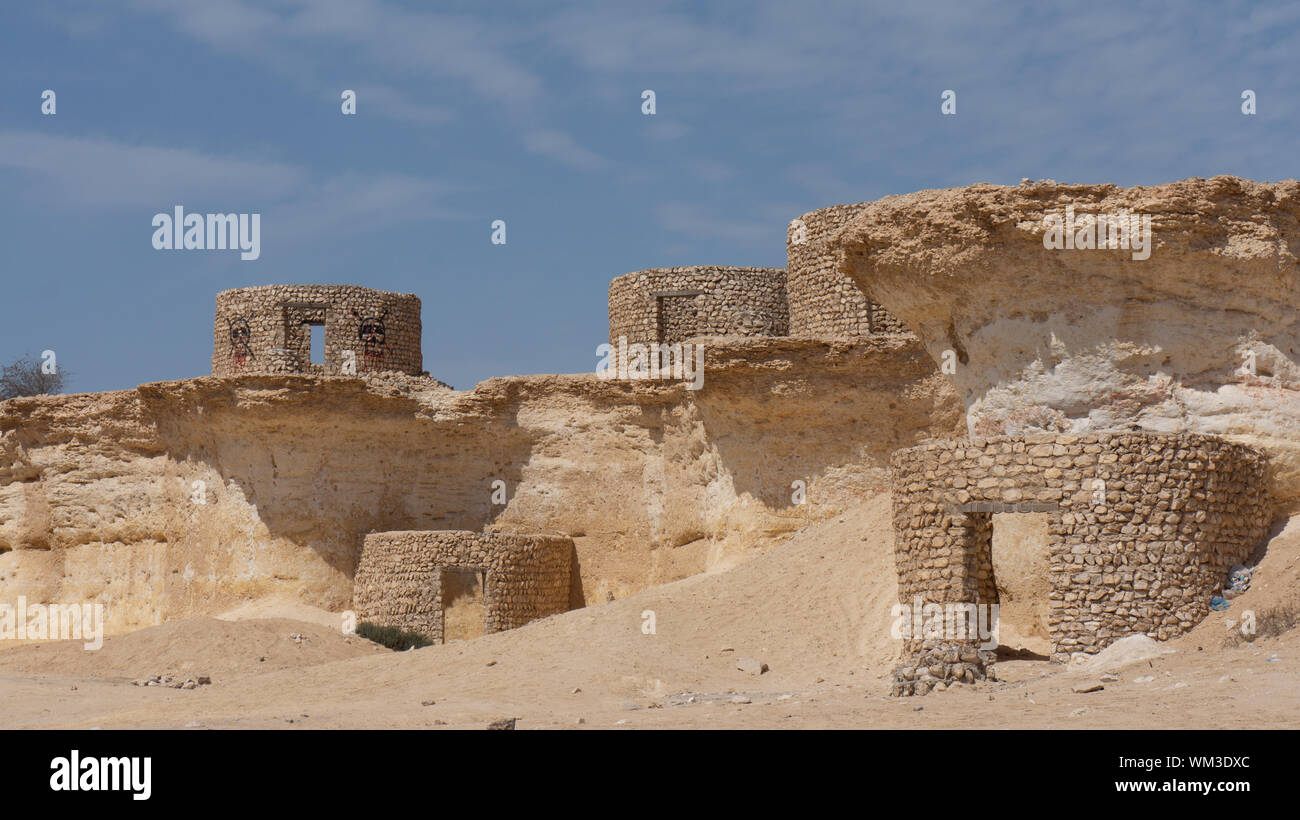 Rocks and a fortress in the desert in Doha, Qatar Stock Photo - Alamy