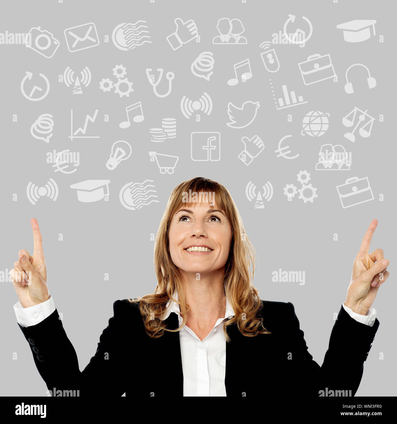 Smiling woman showing drawing and sketching icons Stock Photo - Alamy