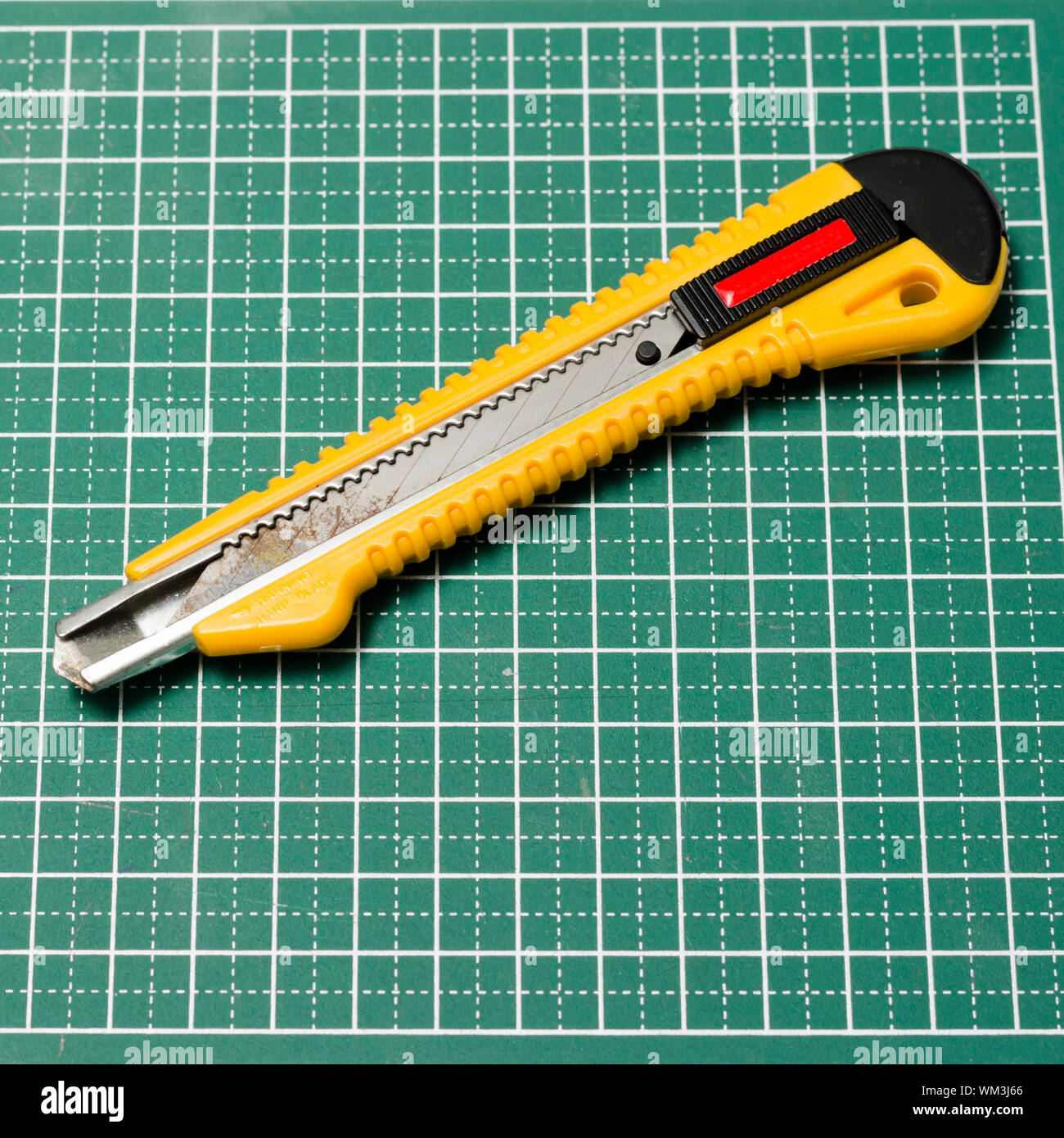 cutter knife on cutting board Stock Photo - Alamy