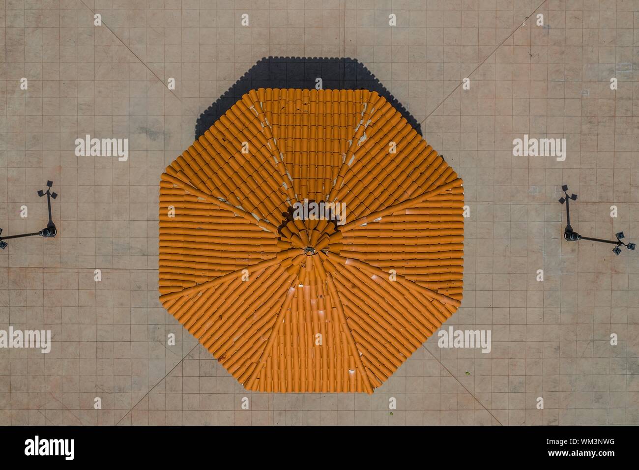 Aerial view of orange octagonal kiosk in the center of the public ...