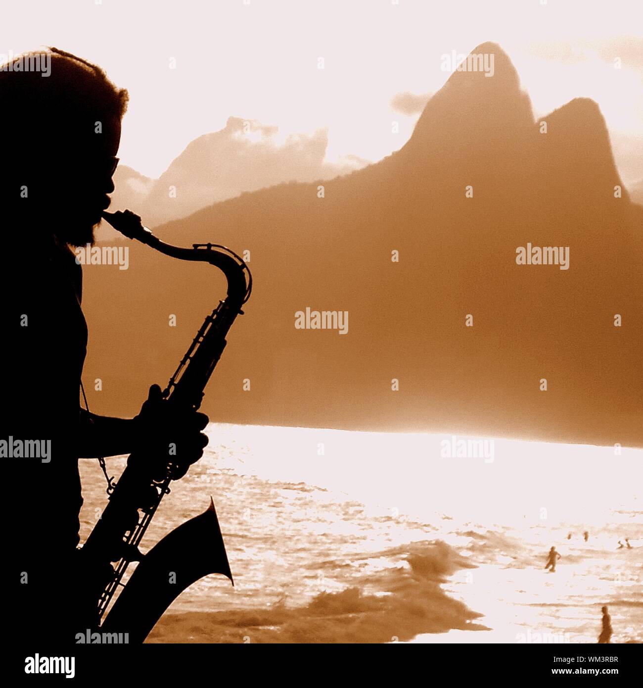 Silhouette man playing saxophone sunset hi-res stock photography and ...