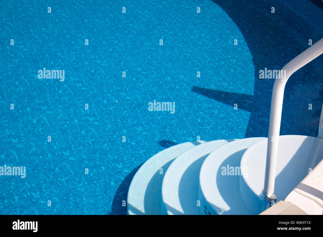 White steps going into an empty blue backyard pool Stock Photo - Alamy