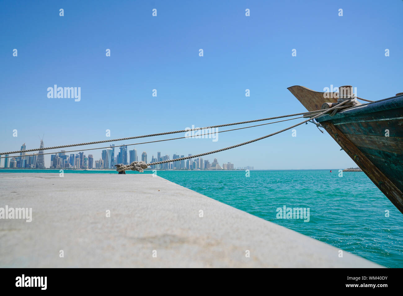 Al Dafna architecturally modern sykline across Dhow Harbour with bow ...