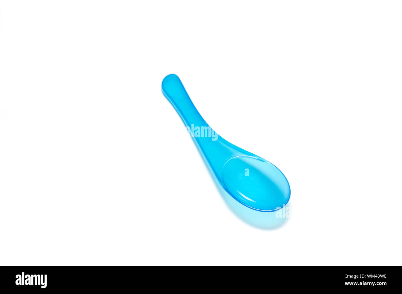 blue plastic spoon on a white background Stock Photo - Alamy