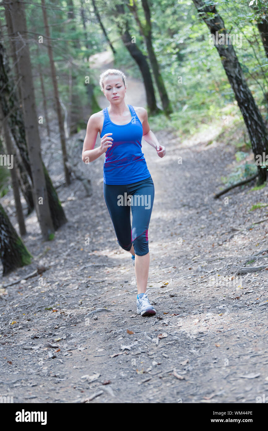 Pretty young girl runner in the forest Stock Photo - Alamy